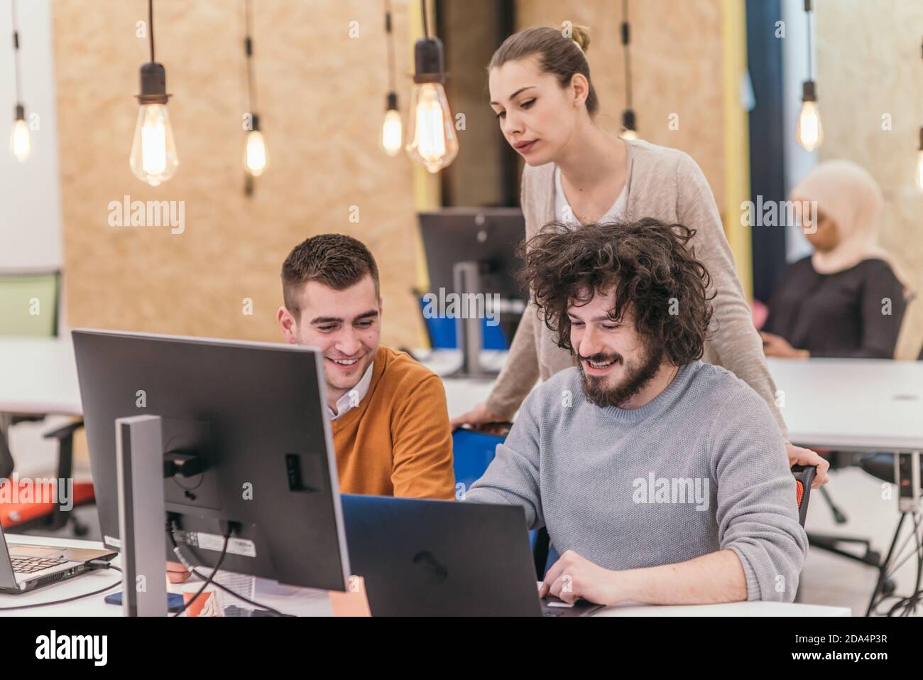 Group of coworkers, colleagues having fun at the office while chatting ...