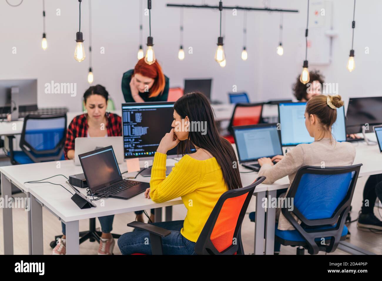 Group of multi-ethnic colleagues working on desktop computers and ...
