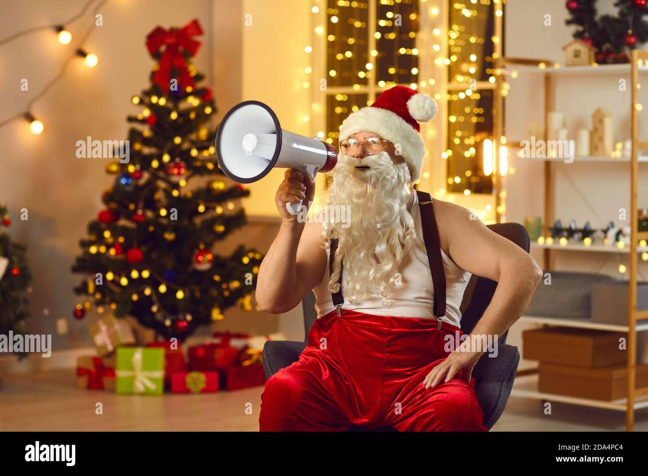 Santa sitting in armchair with megaphone announcing the start of big ...