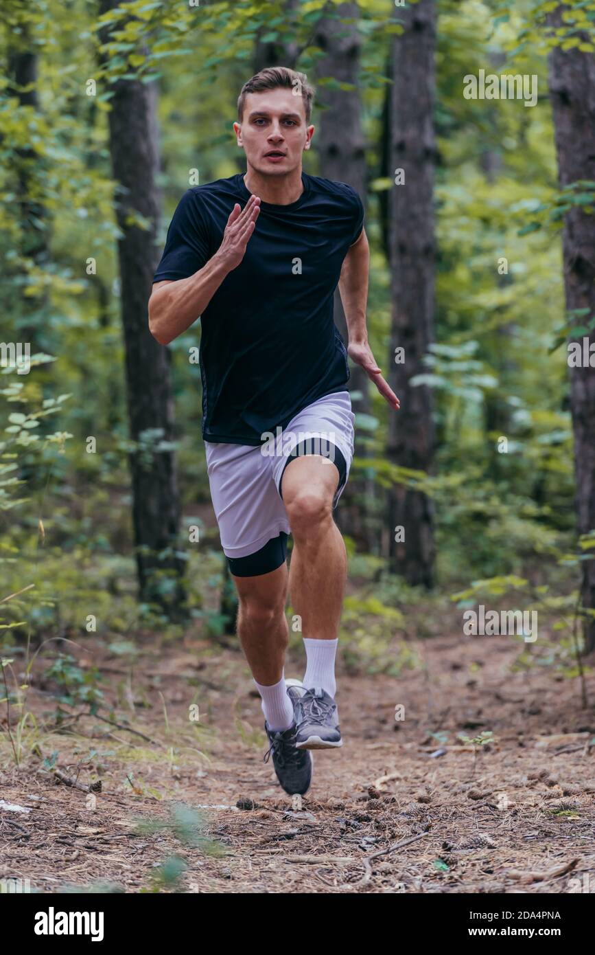 Close up picture of a handsome jogger jogging in the forest Stock Photo ...