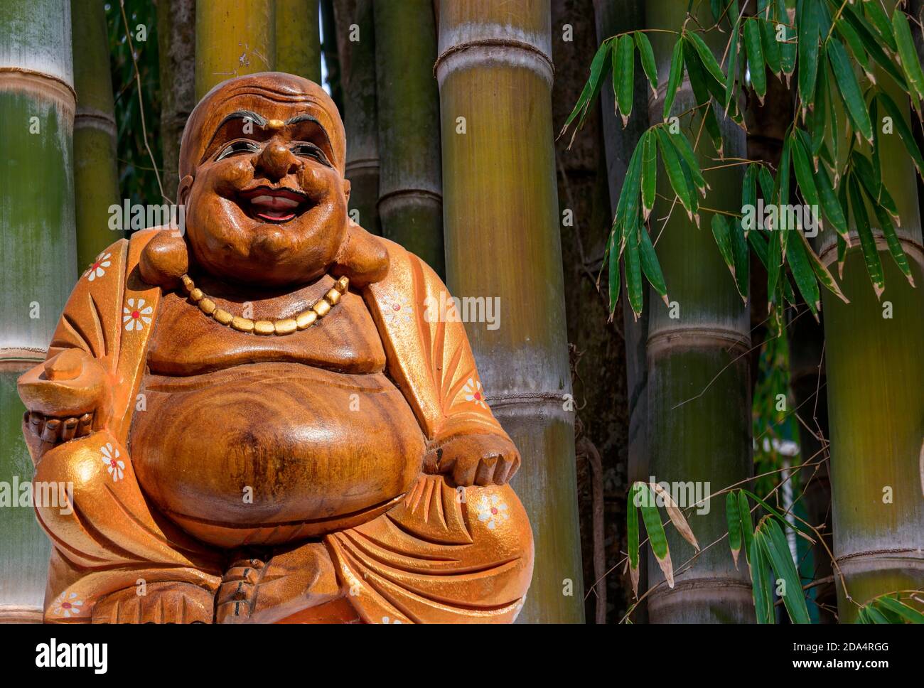 Selective focus shot of fat buddha statue with bamboos background Stock ...