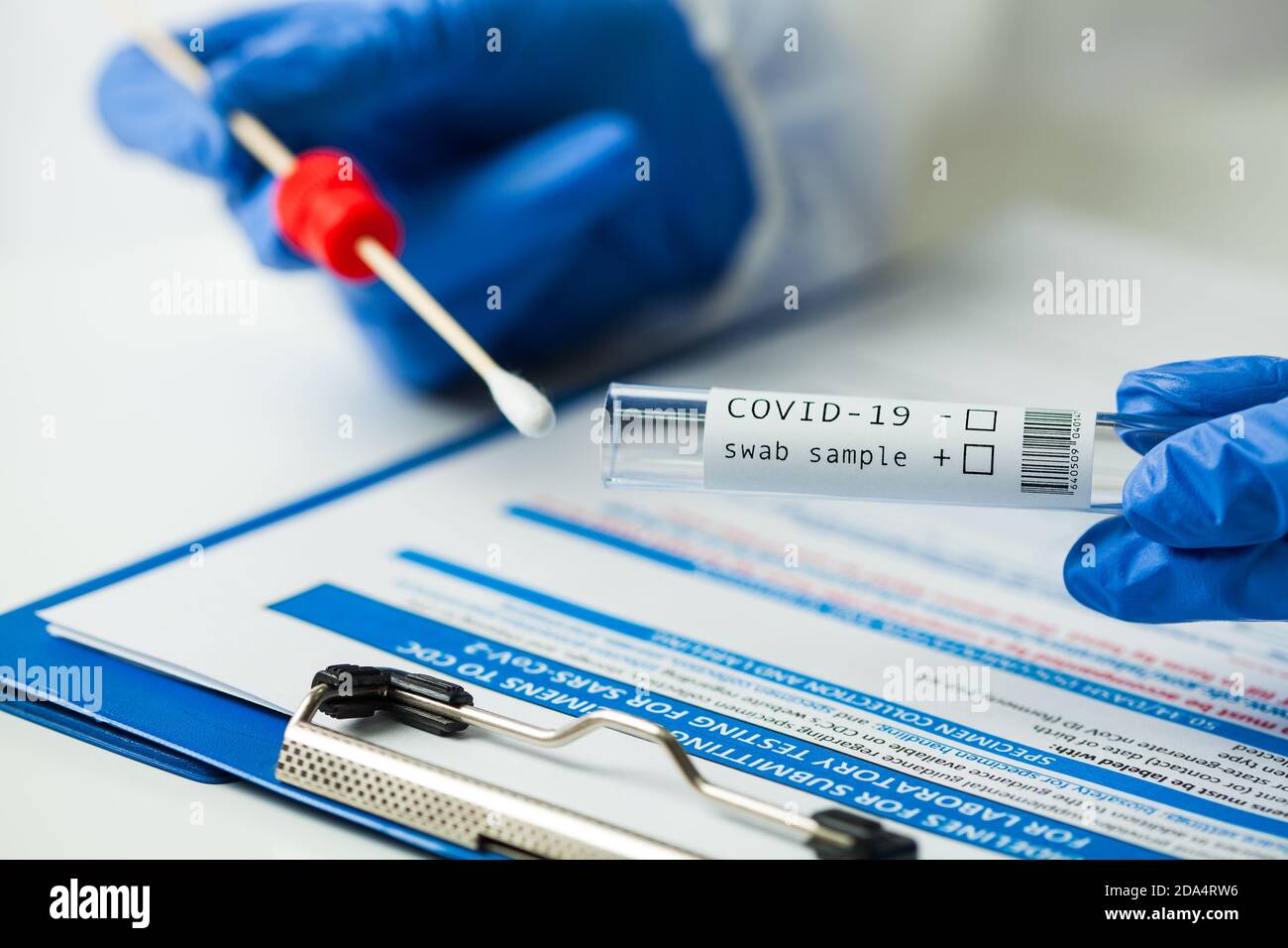 Medical worker holding Coronavirus COVID-19 NP OP swab sample test kit ...