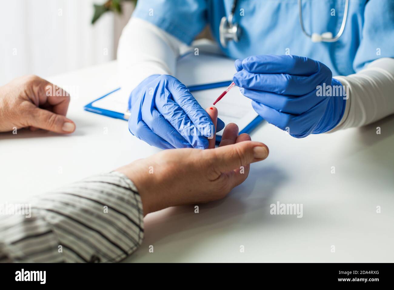 NHS UK doctor taking patient blood sample,serologic finger prick PRP ...