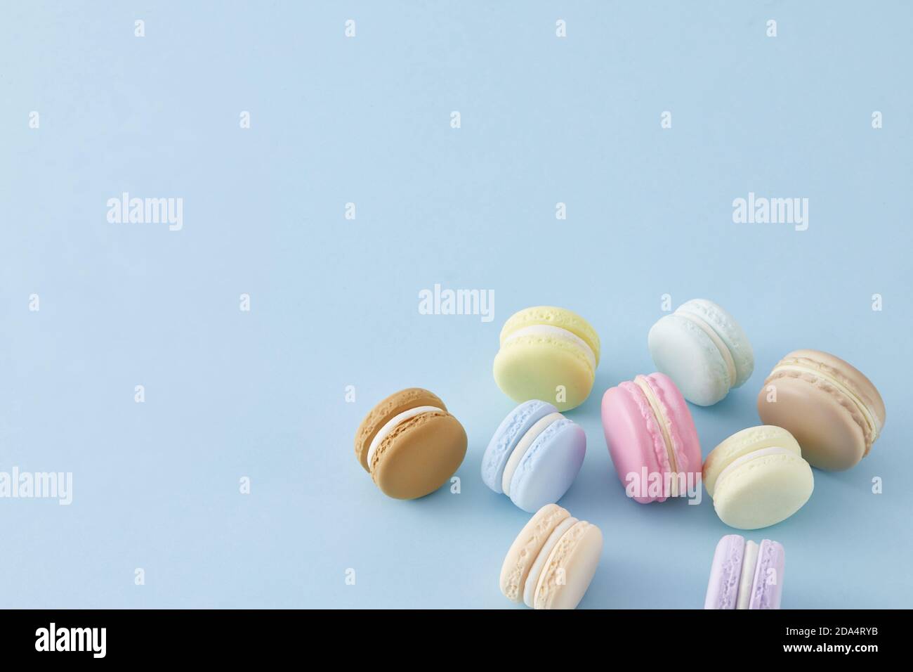 Closeup of various colorful macaroons isolated on a light blue ...