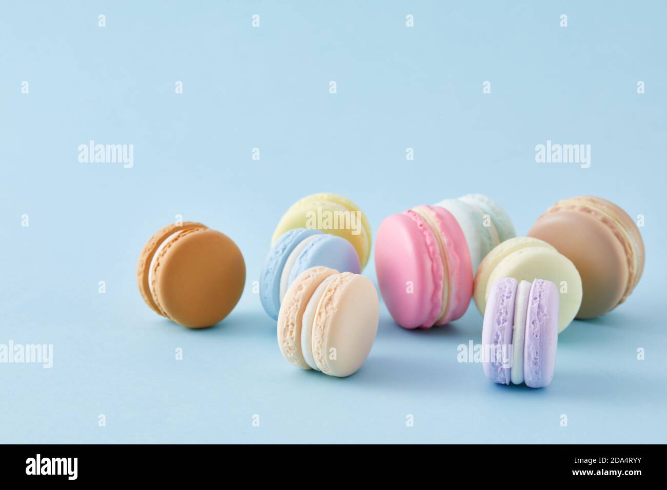 Closeup of various colorful macaroons isolated on a light blue ...