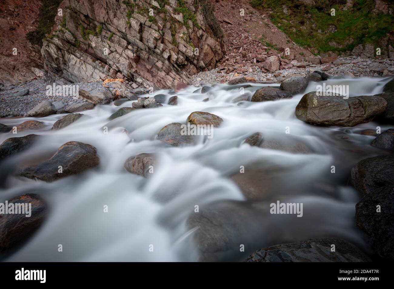 Long exposure of the river Heddon flowing onto the beach at Heddons ...