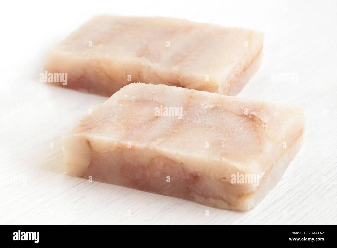 Two quick frozen fish fillet blocks isolated on white Stock Photo - Alamy