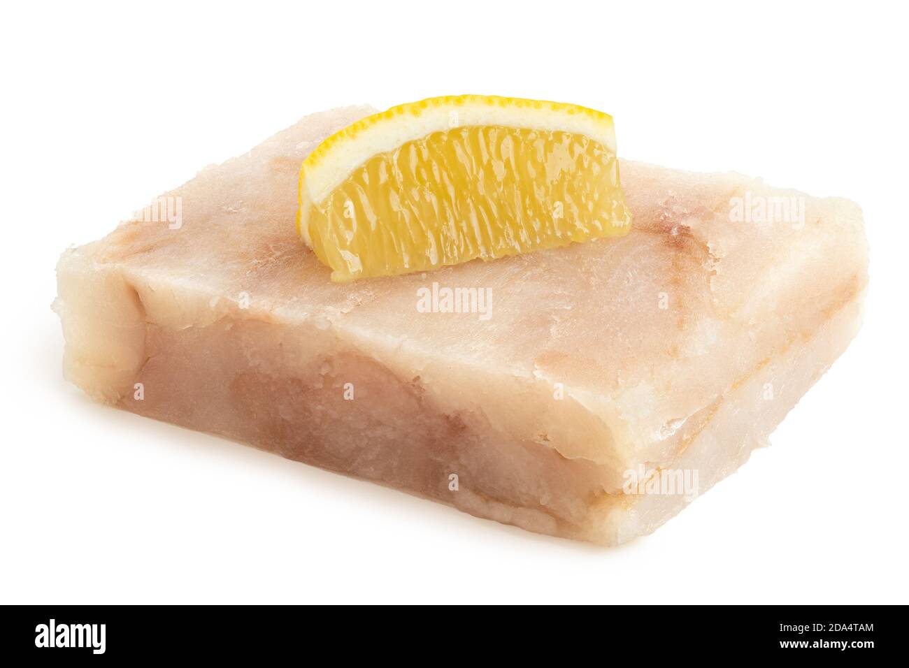 Quick frozen fish fillet block with a lemon wedge isolated on white ...