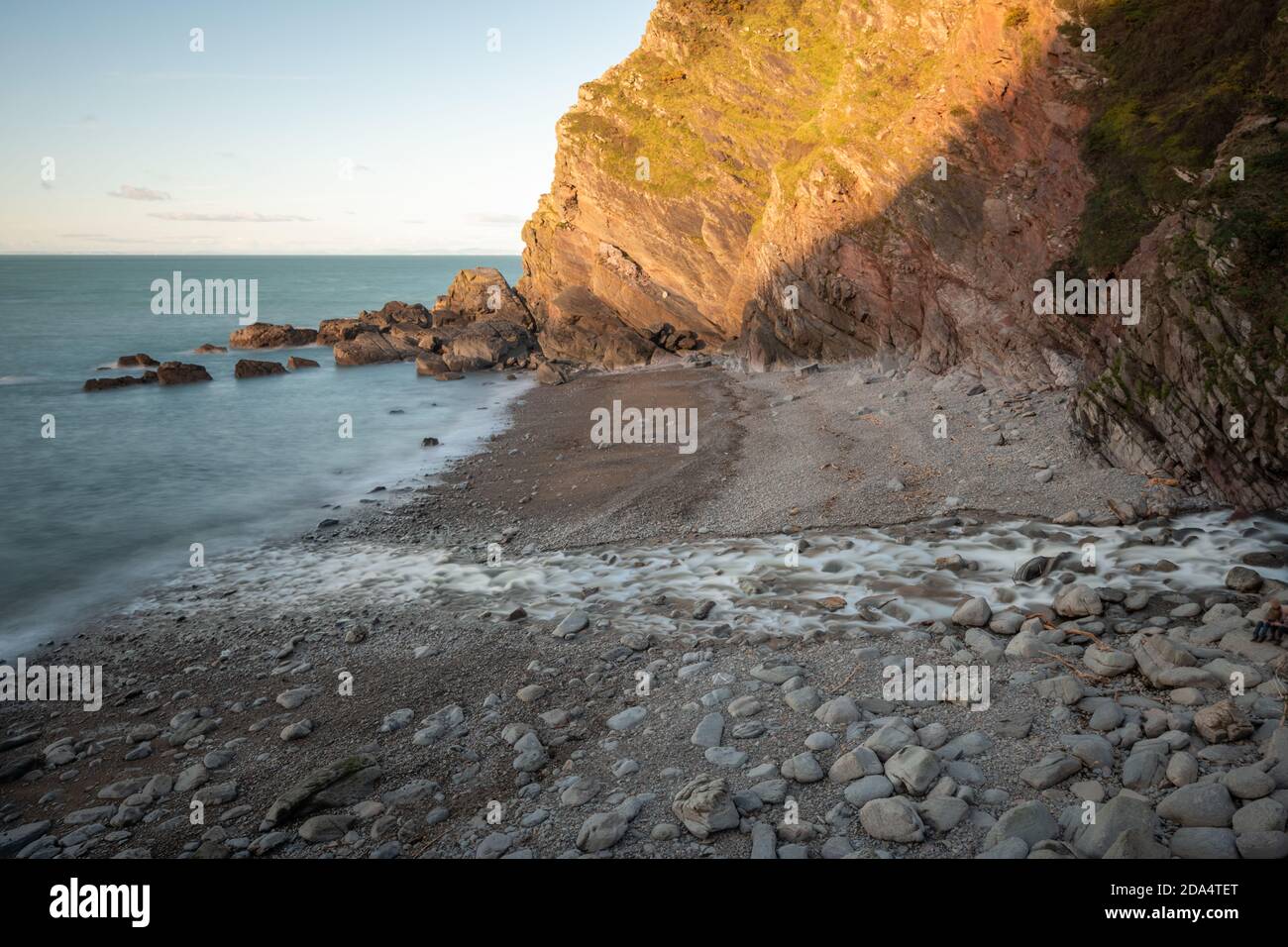 Long exposure of the river Heddon flowing onto the beach at Heddons ...