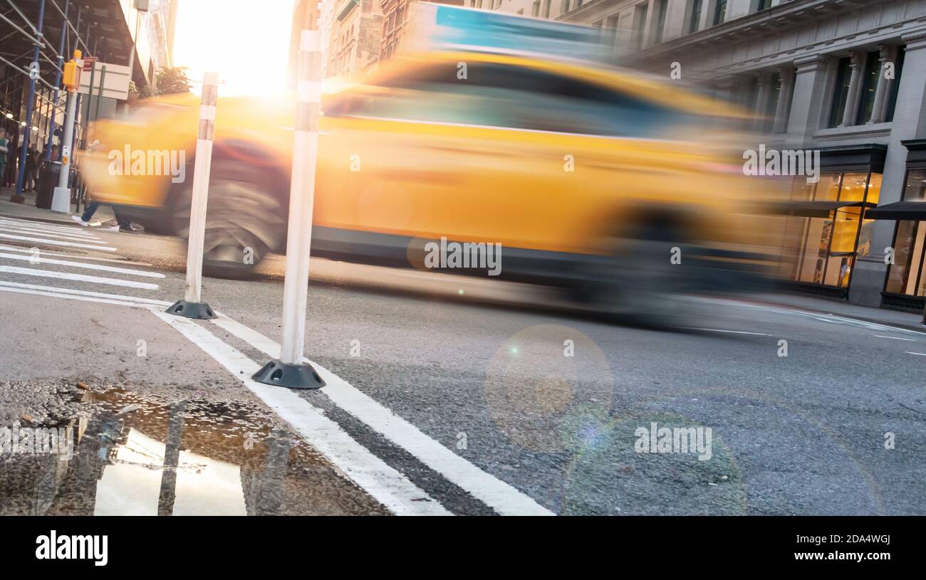 NYC yellow taxi cab driving down the street in Manhattan, New York City ...