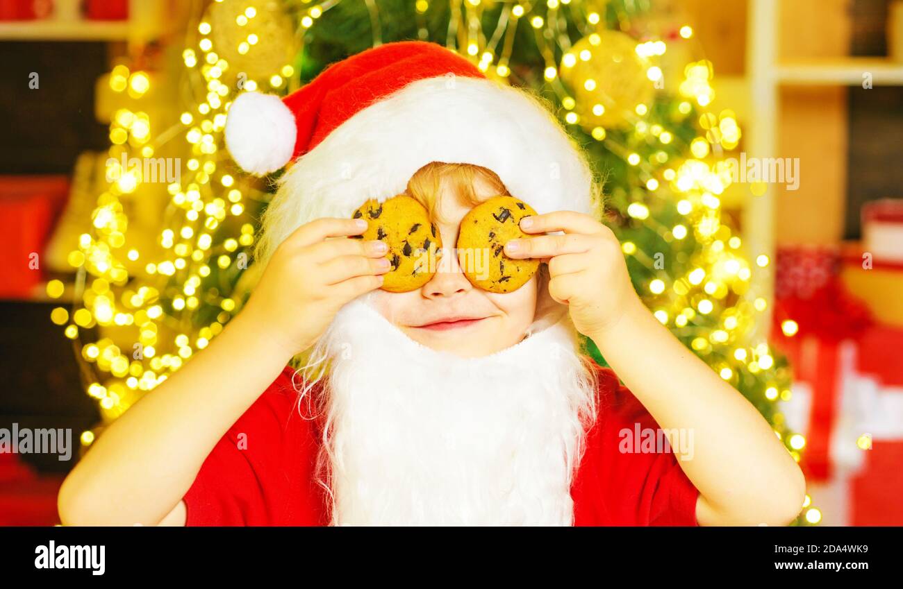 Santa - funny child picking cookie. Santa boy child eating cookies and ...