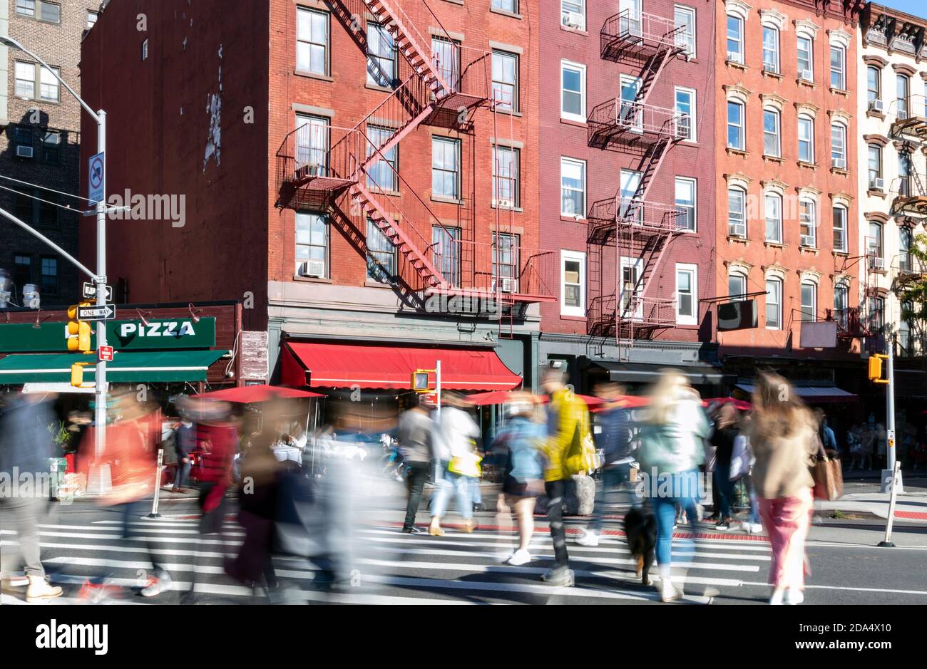 Busy street scene with crowds of people walking through the ...