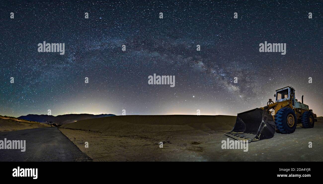 Front loader vehicle in a field under starry night sky Stock Photo - Alamy
