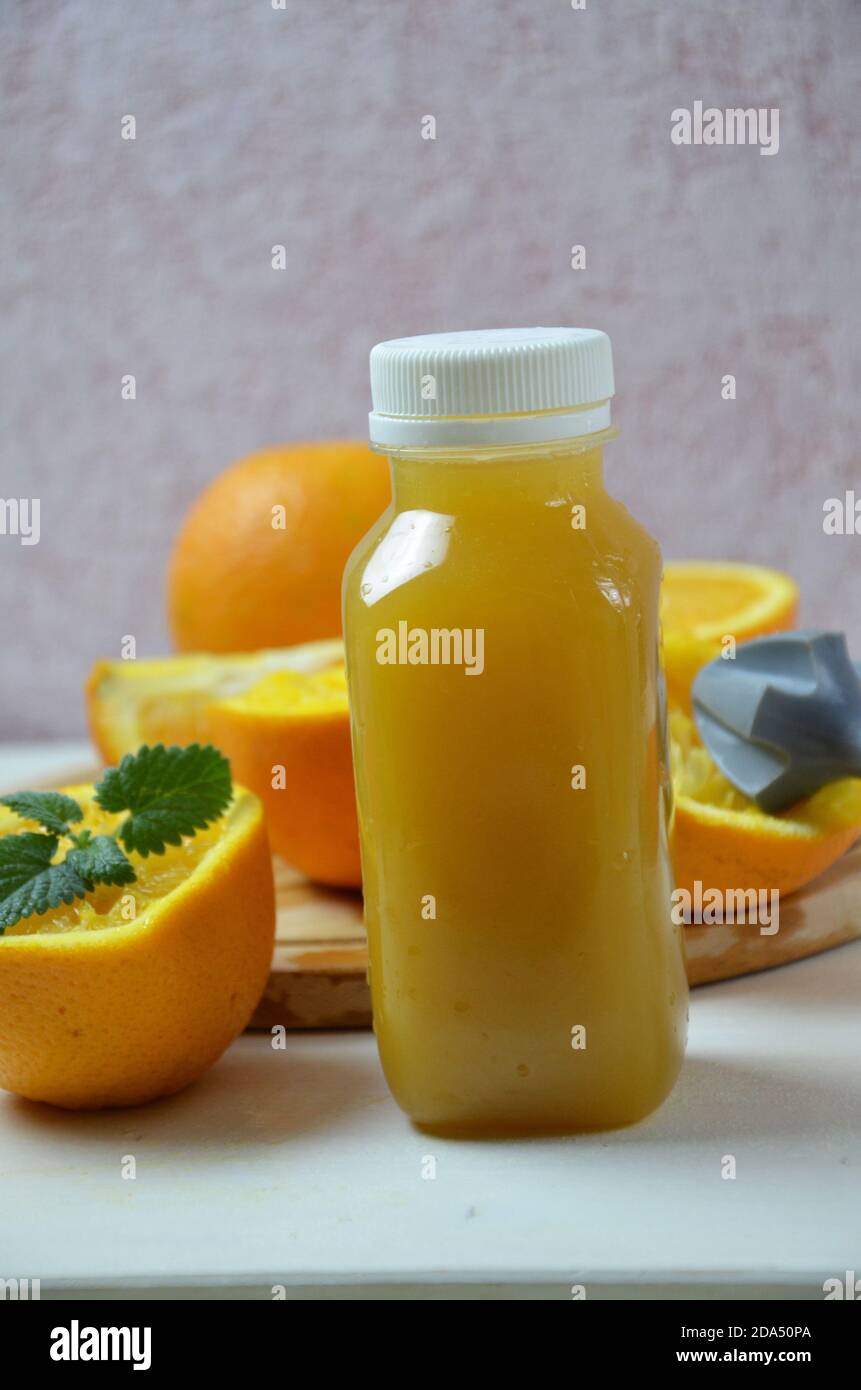 Bottle of orange juice shot. orange organic freshly squeezed juice in a ...