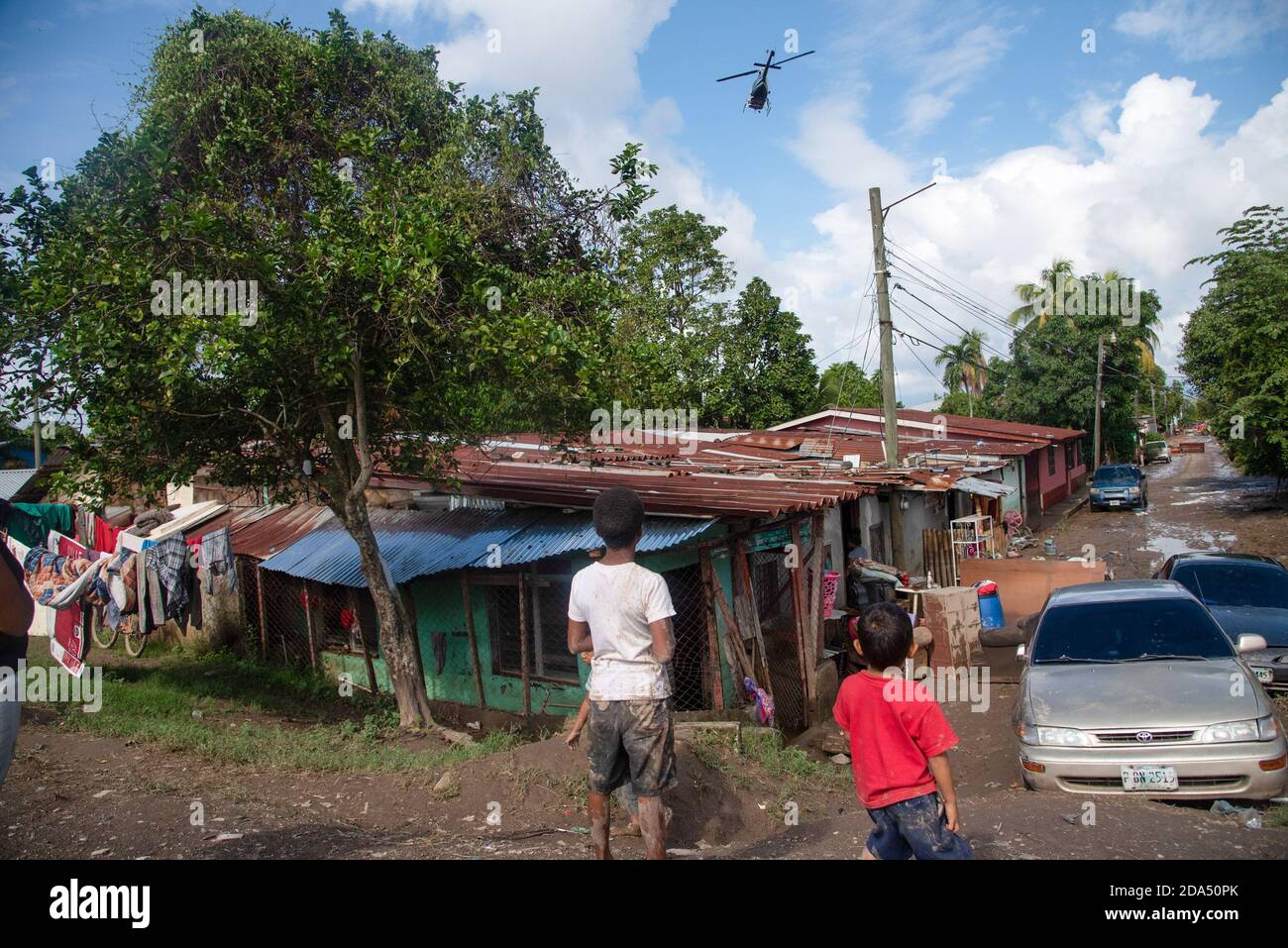 A rescue helicopter flying above a flooded community of La Lima ...