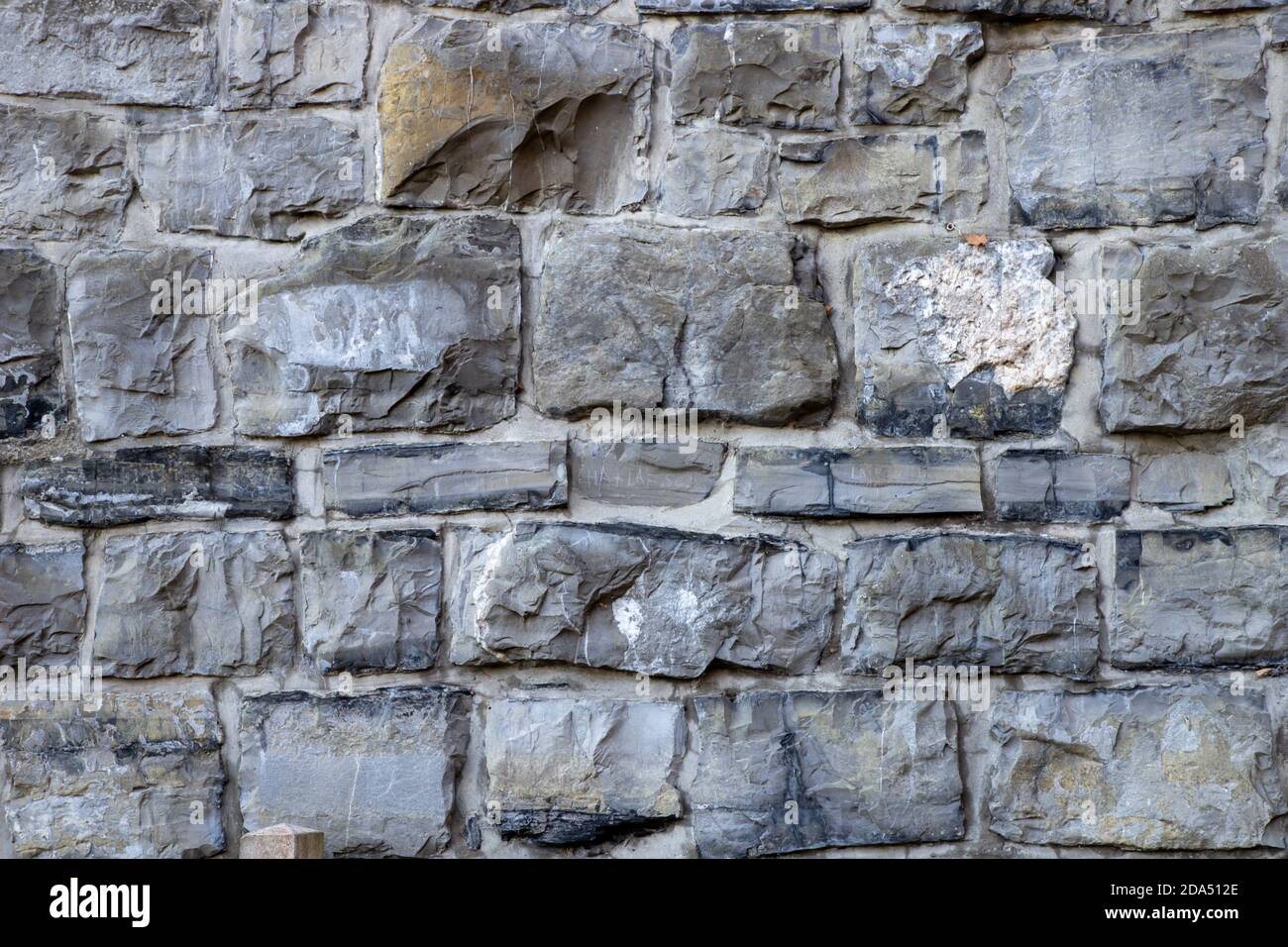 gray brown quarry stone wall as background, wallpaper Stock Photo - Alamy