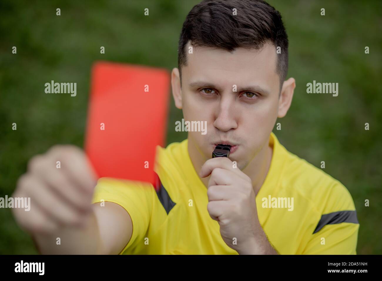 Referee showing a red card to a displeased football or soccer player ...