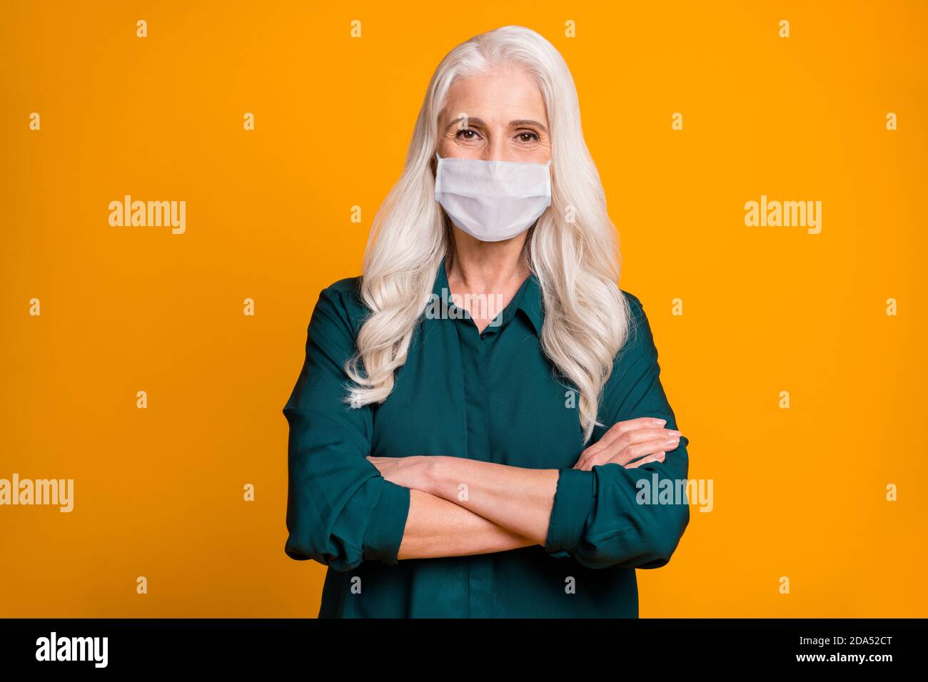 Photo of grandma with hands crossed wear white face mask isolated ...
