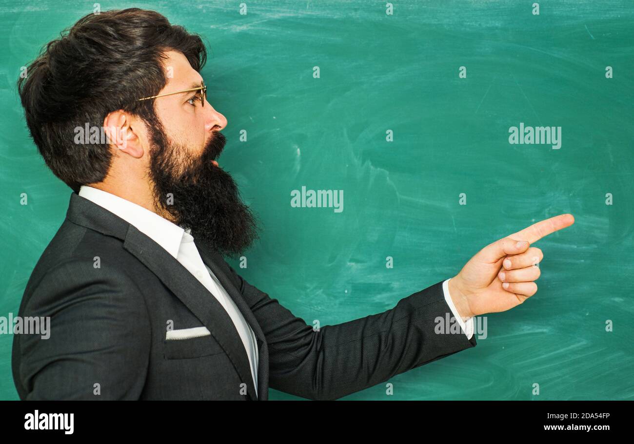 Bearded professor at school lesson at desks in classroom. Education ...