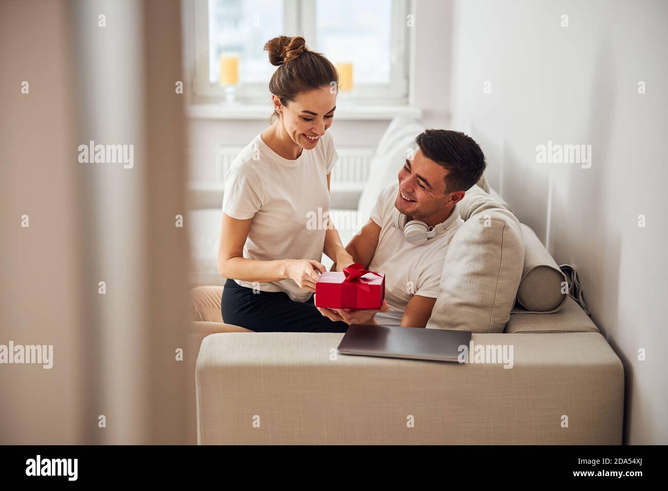 Wife receiving a present from her husband Stock Photo - Alamy