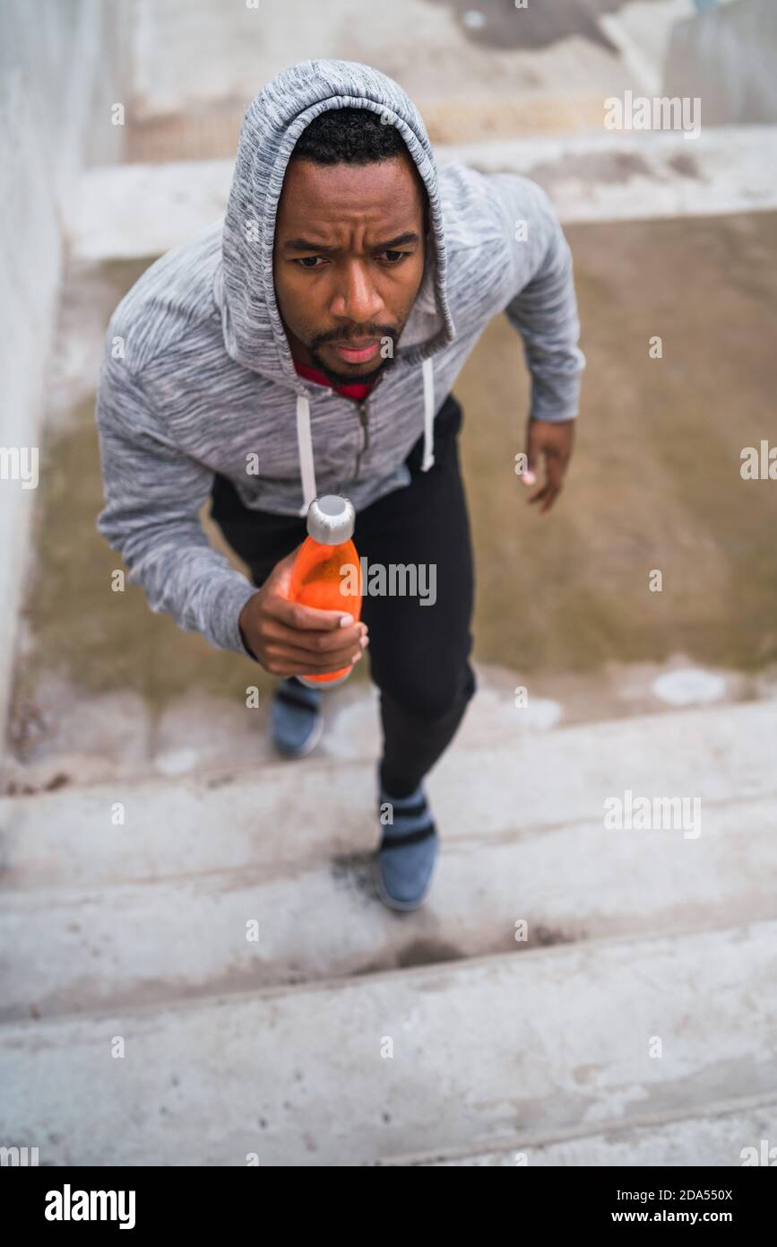 Sport man running up on stairs Stock Photo - Alamy