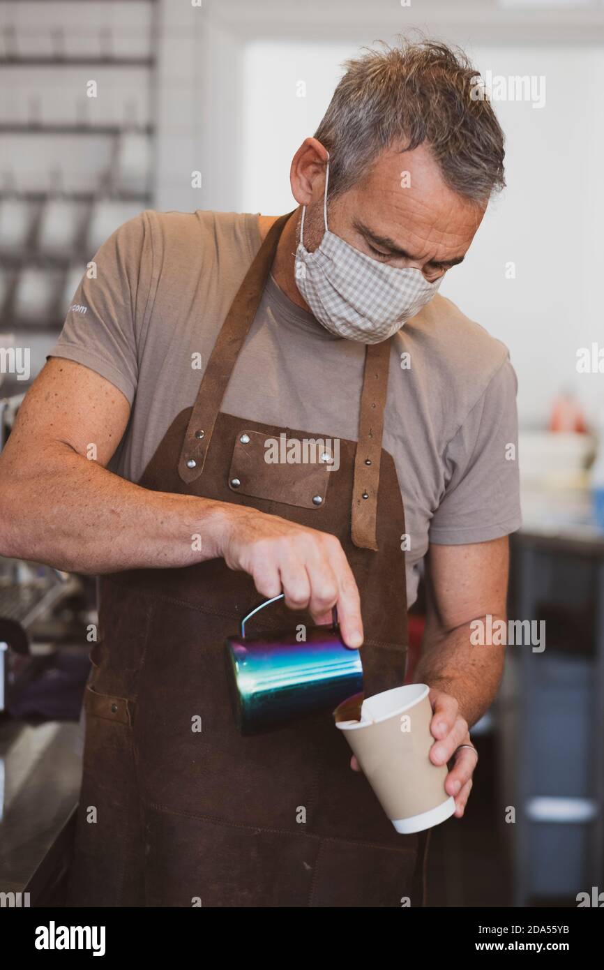 Male barista wearing brown hi-res stock photography and images - Alamy