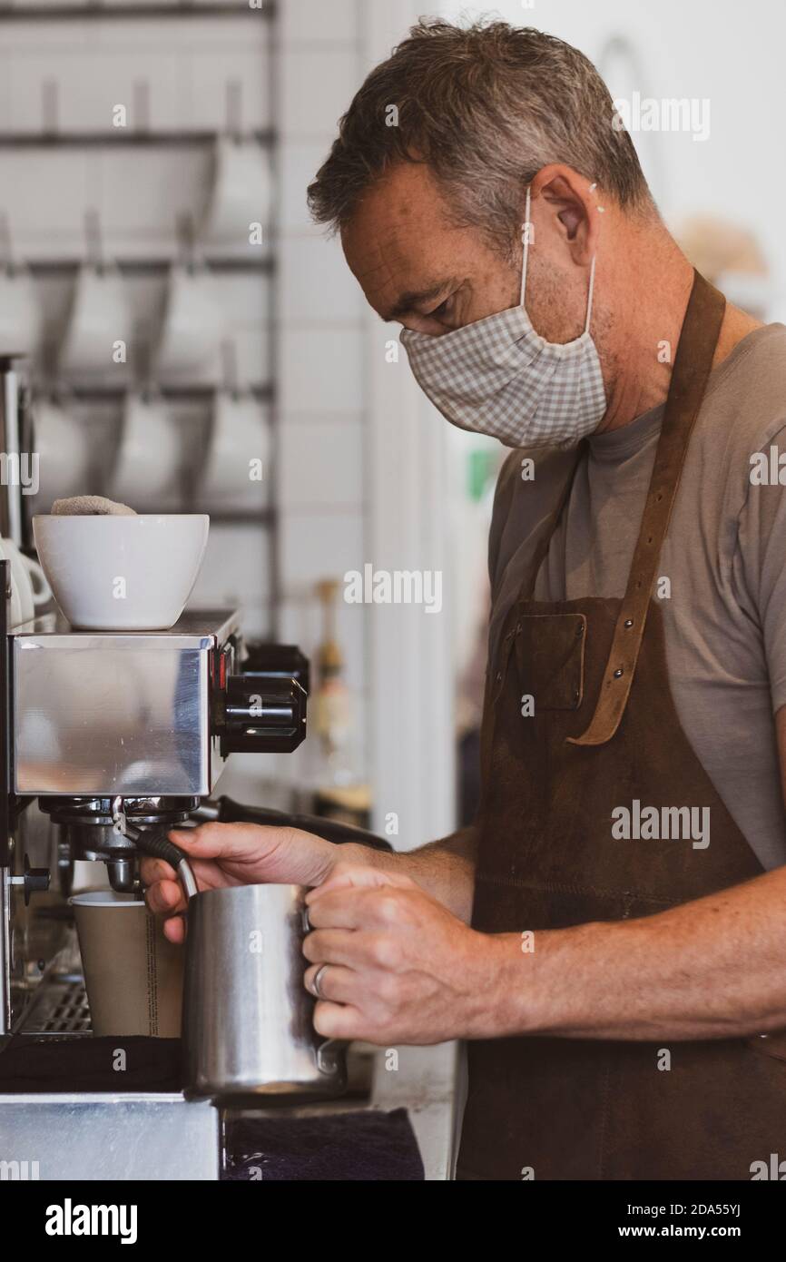 Male barista wearing brown hi-res stock photography and images - Alamy