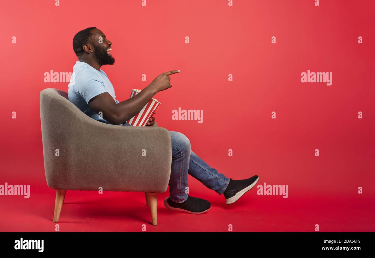 Man has fun watching a film. Concept of entertainment and streaming tv ...