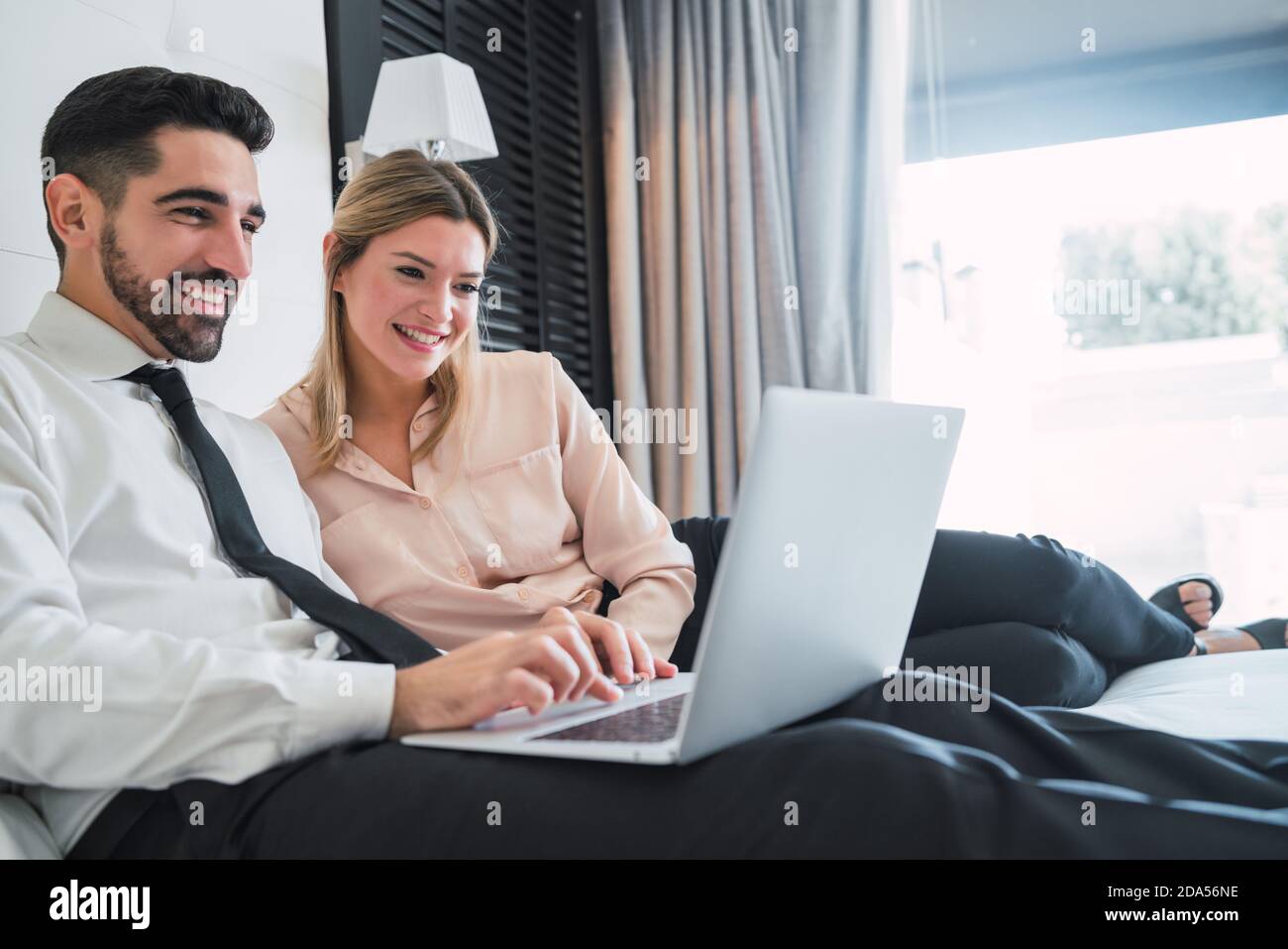 Two business people working together on laptop Stock Photo - Alamy