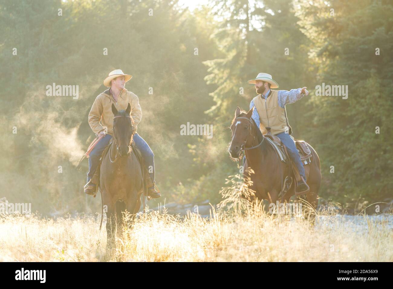 Two cowboys riding horses hi-res stock photography and images - Alamy