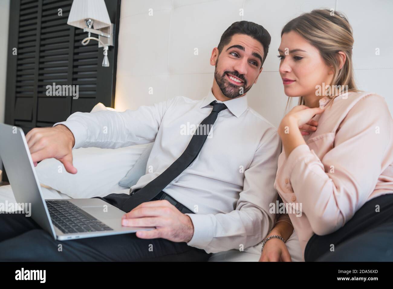 Two business people working together on laptop Stock Photo - Alamy
