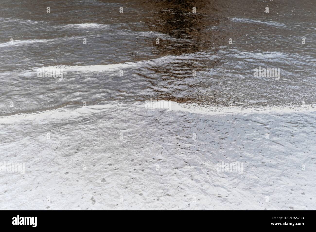 Detail of light ocean waves and ripples on sand, inverted image Stock ...