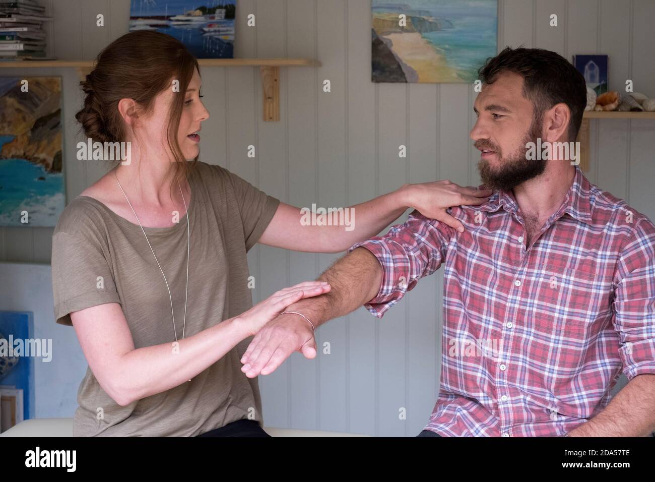 Alternative therapist and man during a consultation, using EFT tapping ...