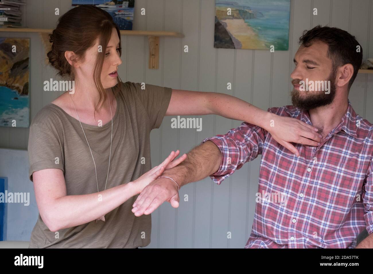 Alternative therapist and man during a consultation, using EFT tapping ...