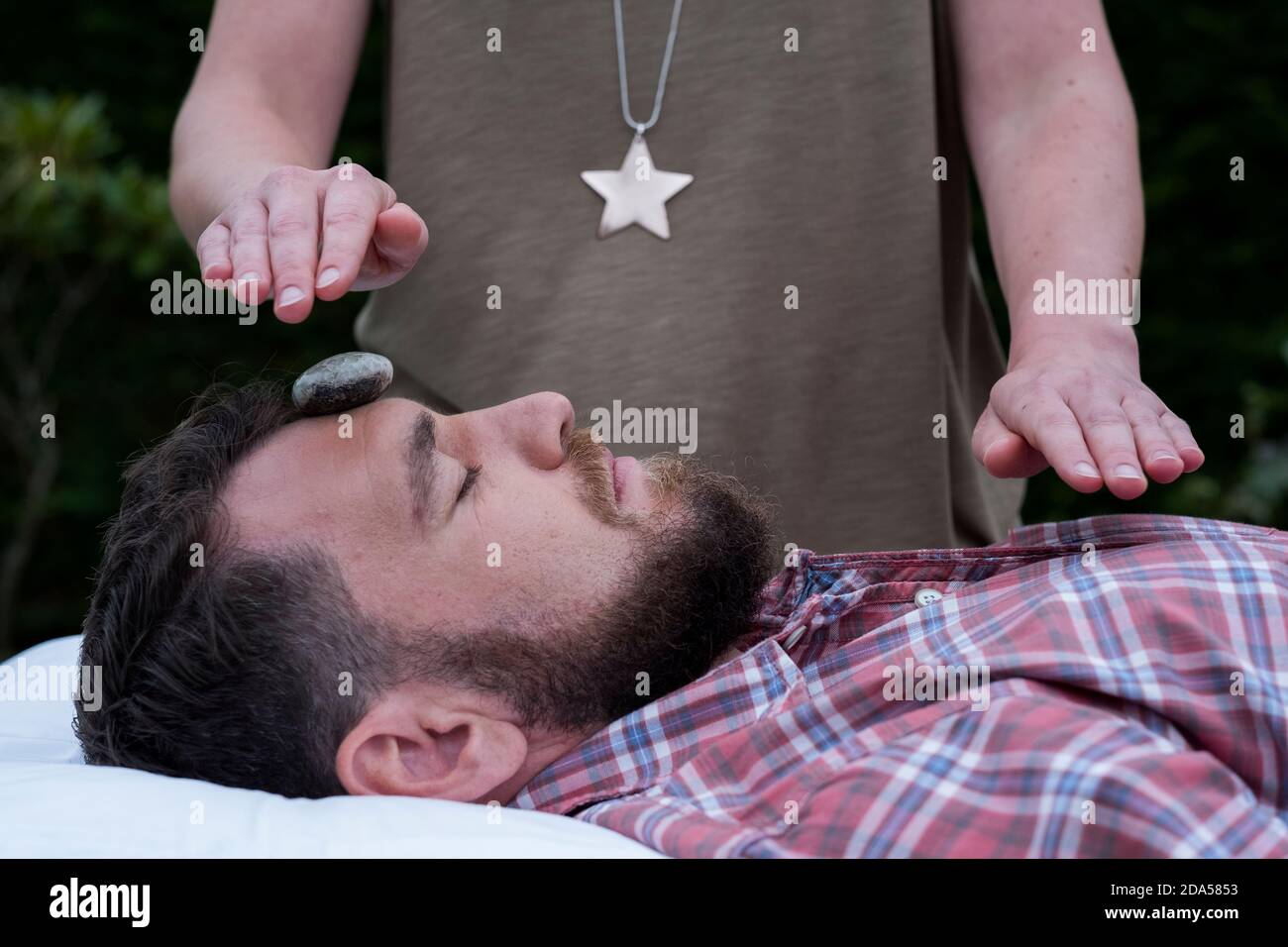 A man on a couch with a stone on his forehead, therapy session Stock ...