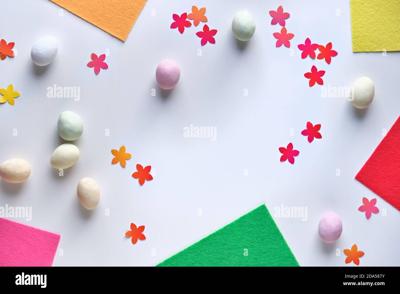 Easter background with sweet eggs, flower confetti and colorful felt ...