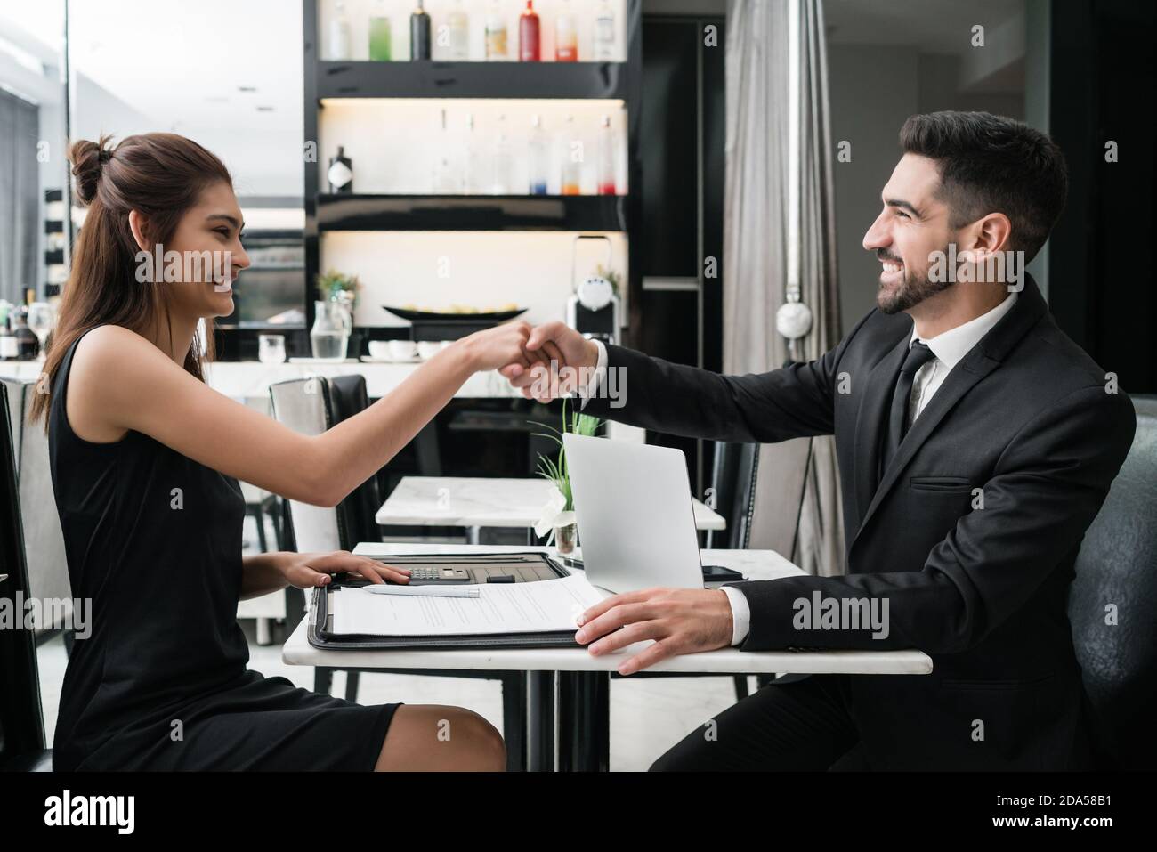 Two business people having meeting and shaking hands Stock Photo - Alamy