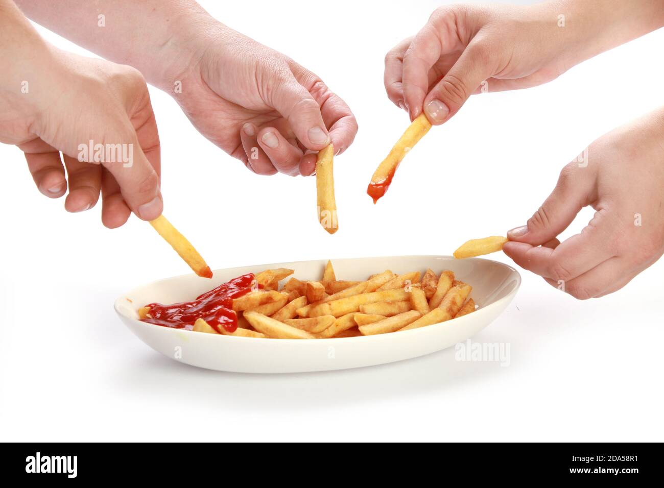 Closeup shot of people eating fries with ketchup Stock Photo - Alamy