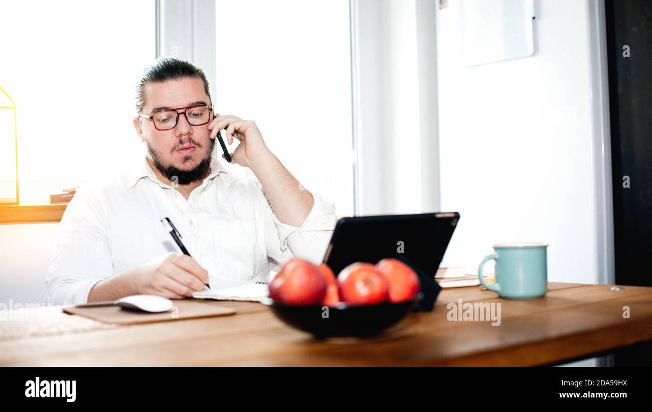Young man during self-isolation works in the kitchen at home Stock ...