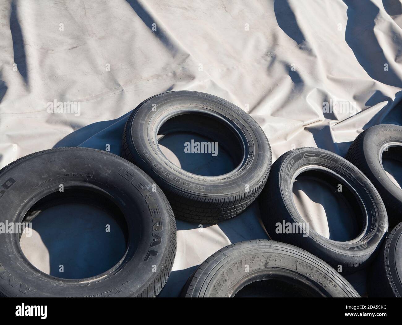 Rubber tires laid out on a tarpaulin, recycling Stock Photo - Alamy