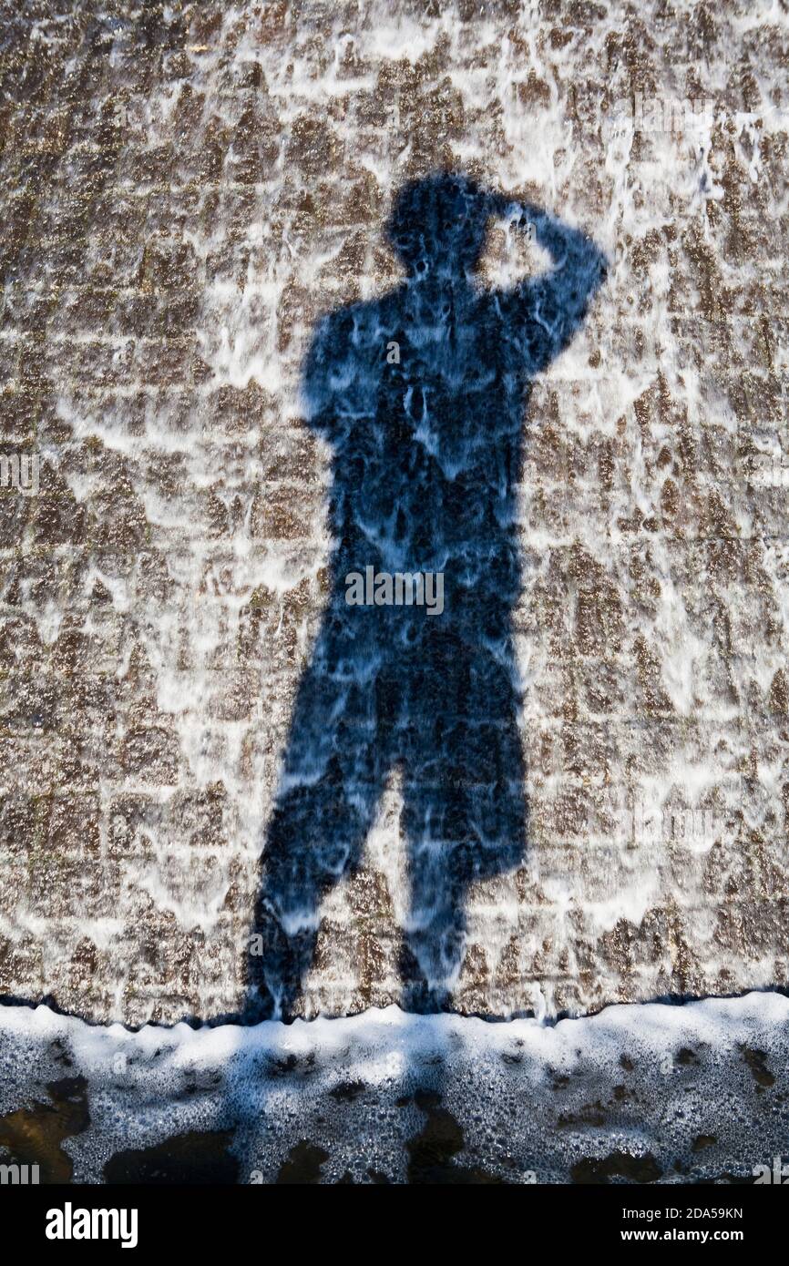 Shadow of an adult against a mottled concrete surface Stock Photo - Alamy