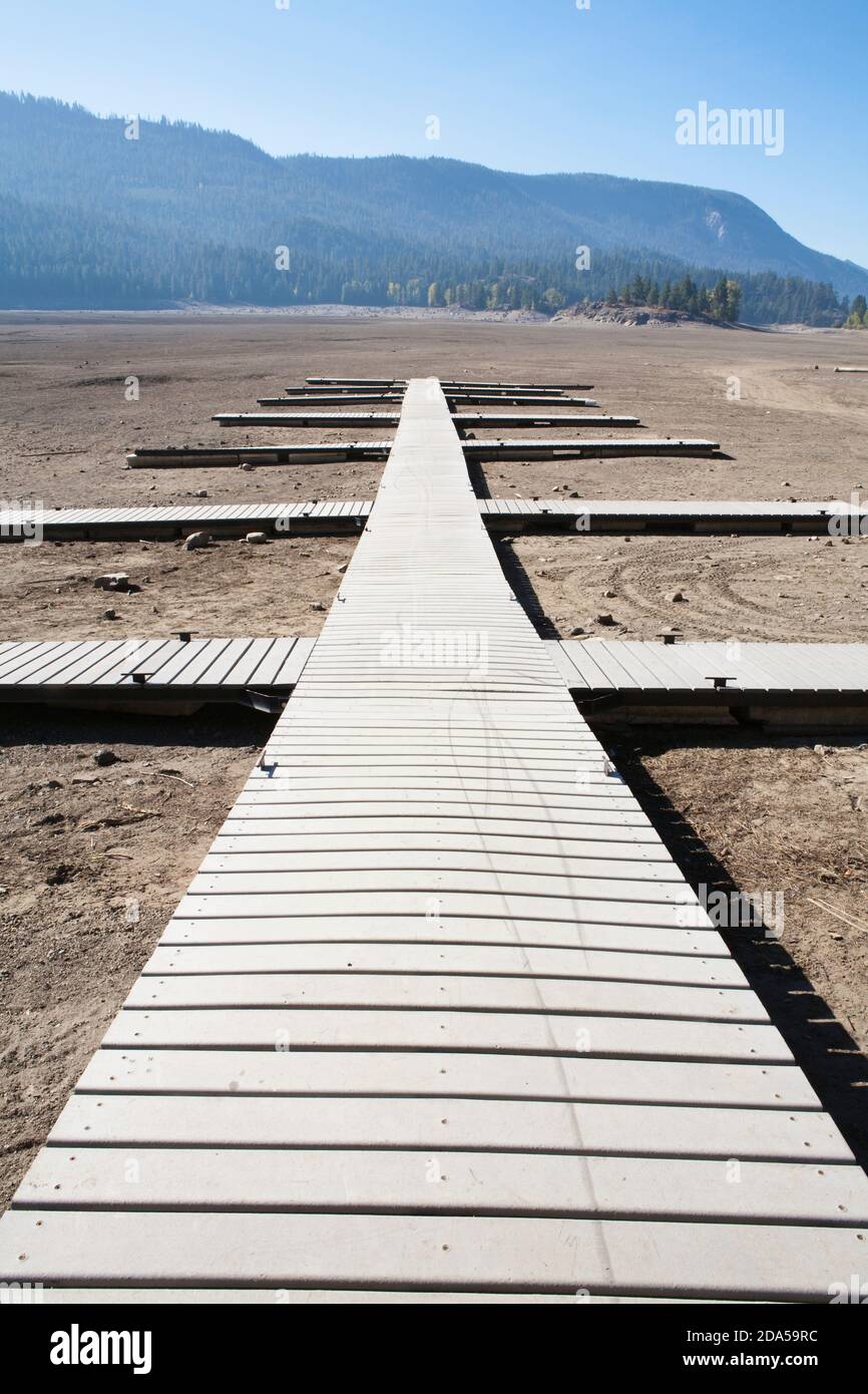 Boardwalk on a dry desert, wooden planks Stock Photo - Alamy