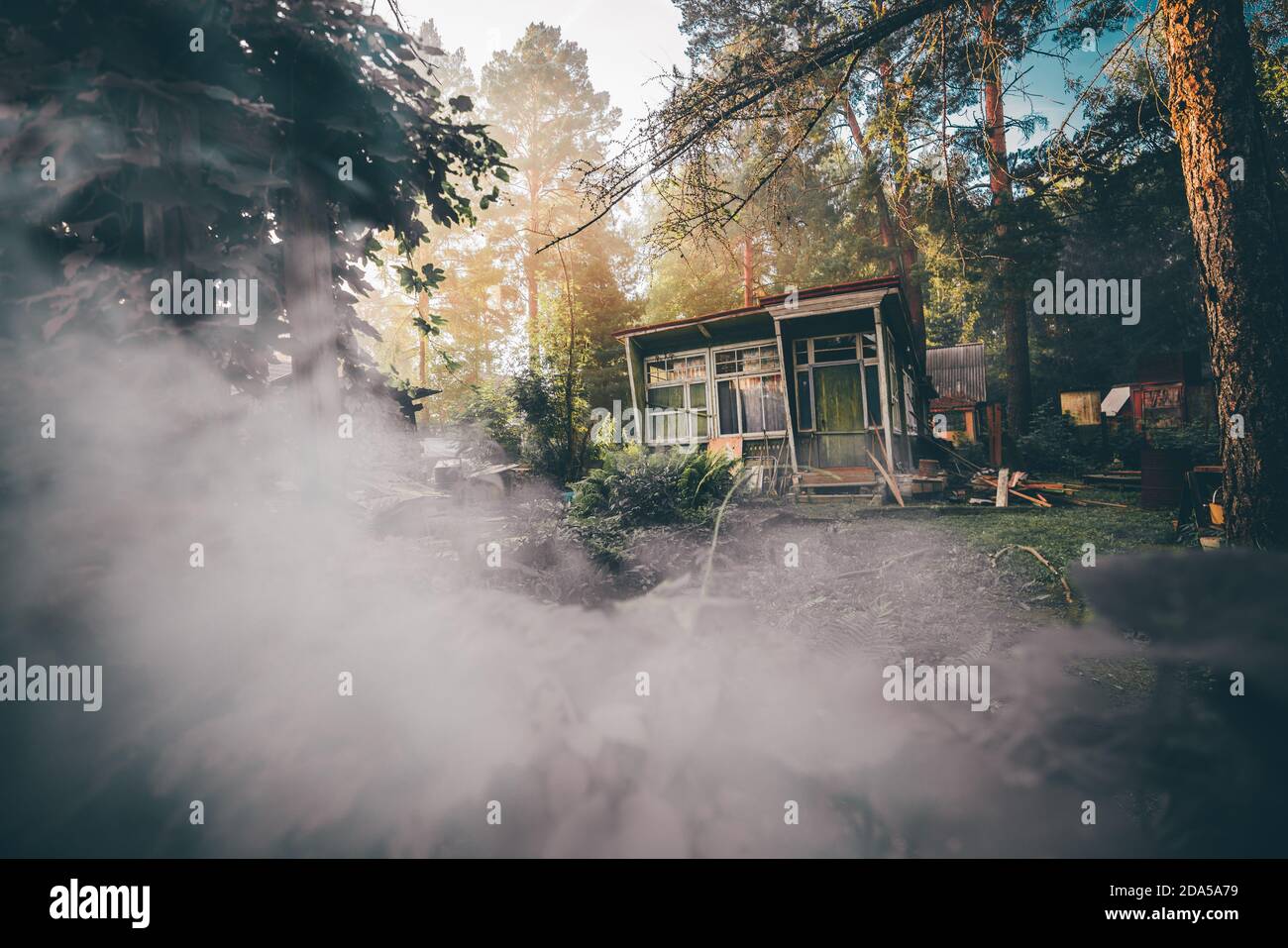 A wide-angle view of an old desolate one-story summer shack with glass ...