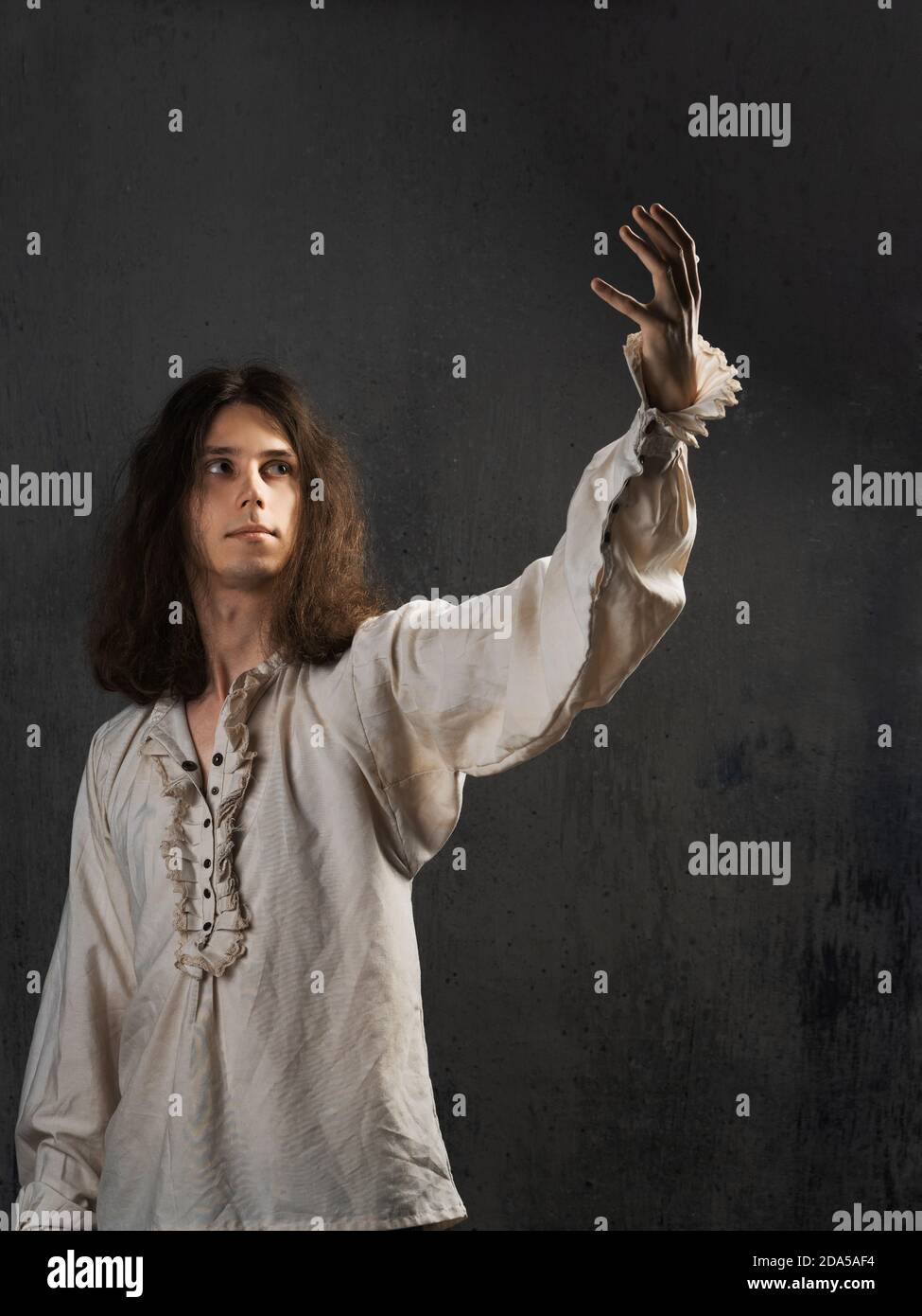 Romantic young man in a medieval costume makes a speech. Theatrical ...