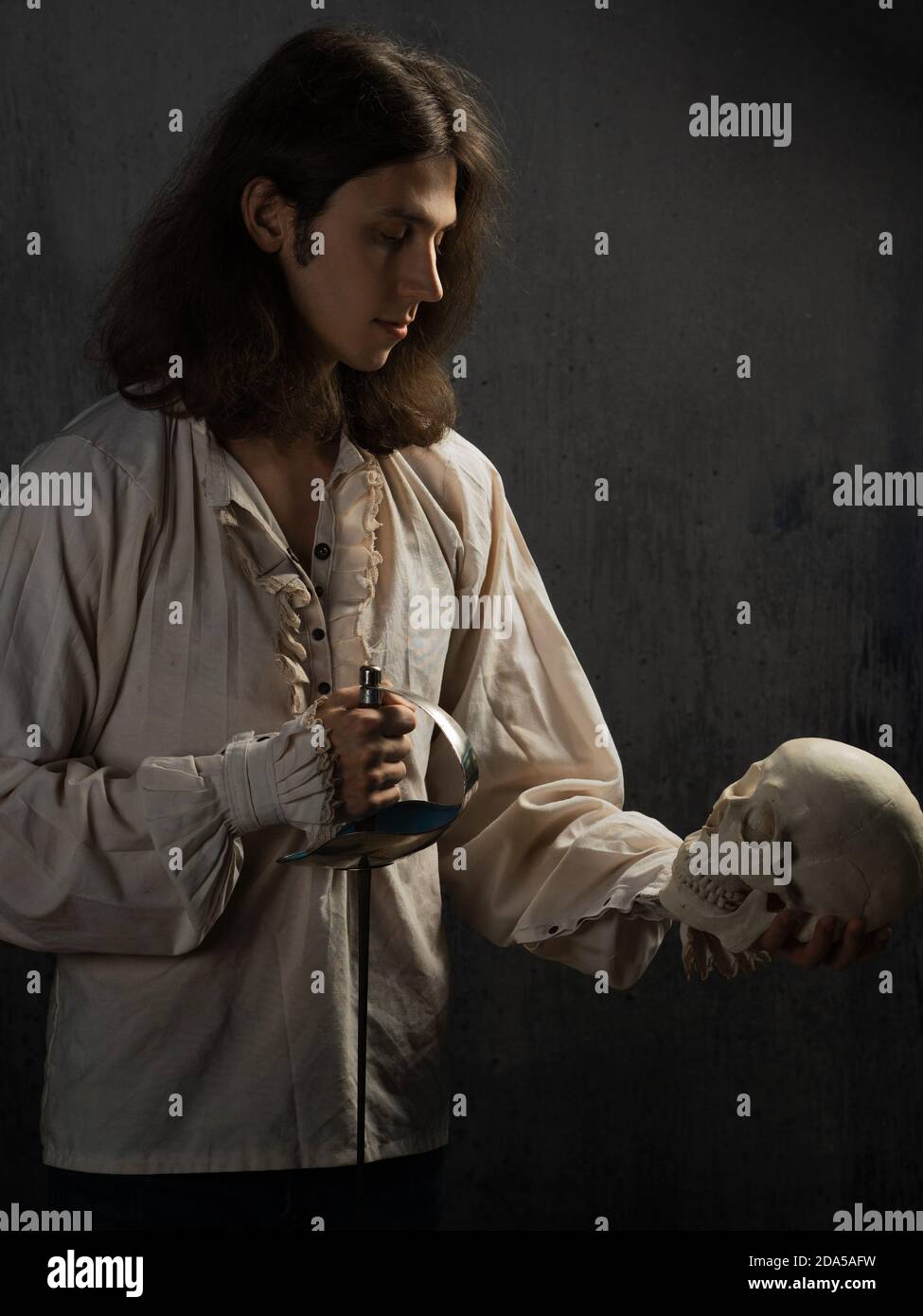A romantic young man in a medieval costume with a sword says a ...