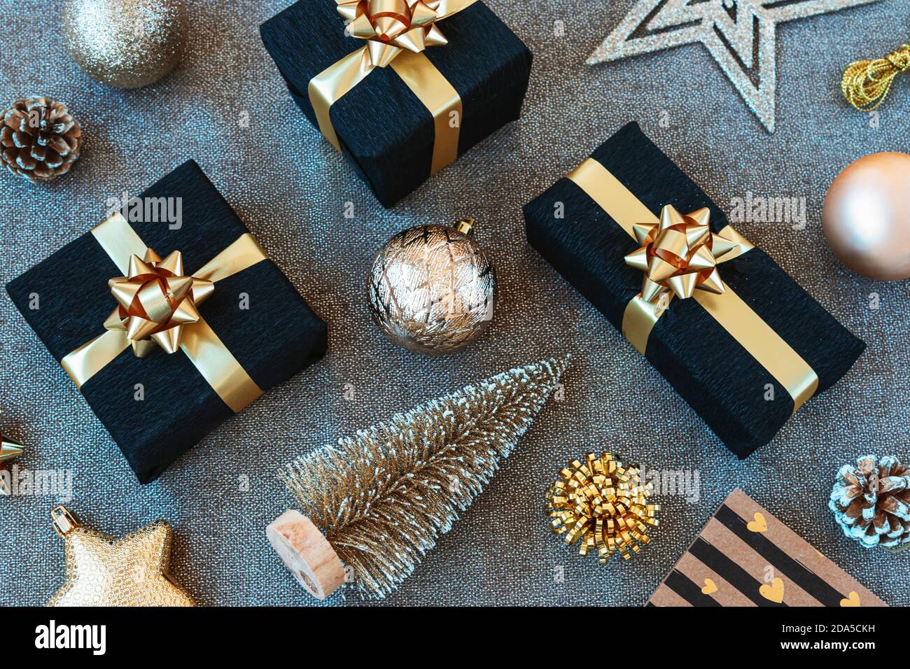 Christmas flat lay, toys, baubles and black wrapped gift boxes with ...