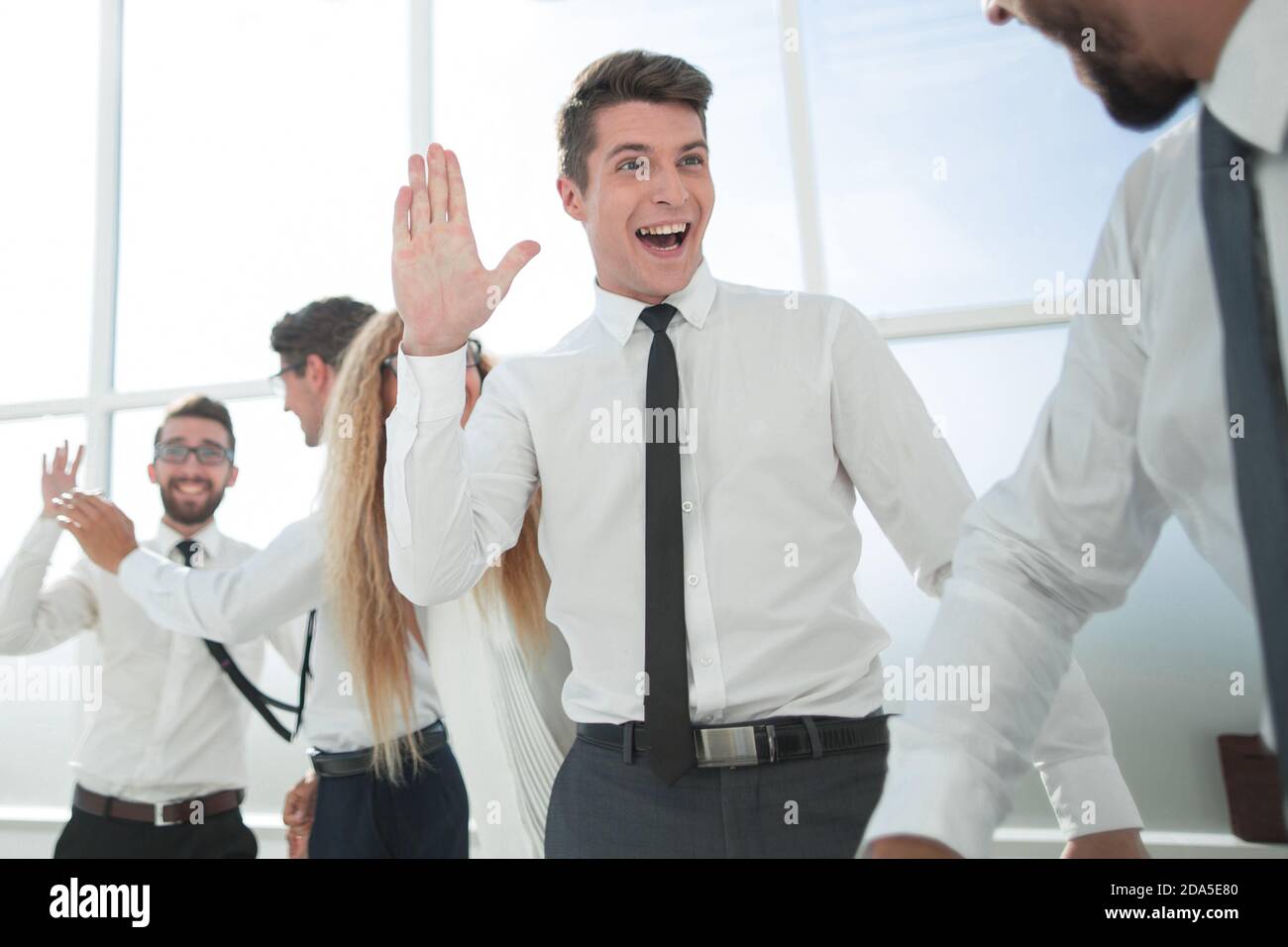 happy business team giving each other high five Stock Photo - Alamy