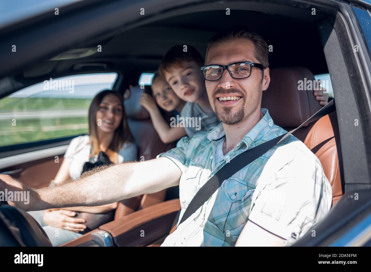 side view.happy father driving a car Stock Photo - Alamy side view.happy father driving a car Stock Photo - Alamy