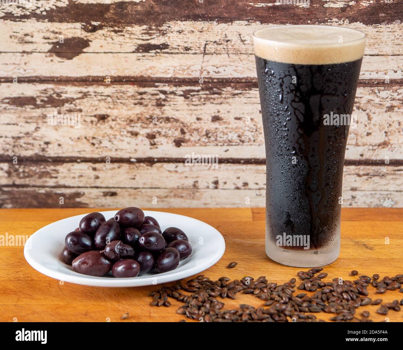 Glass of fresh cold beer on a table with olives and coffee beans Stock ...