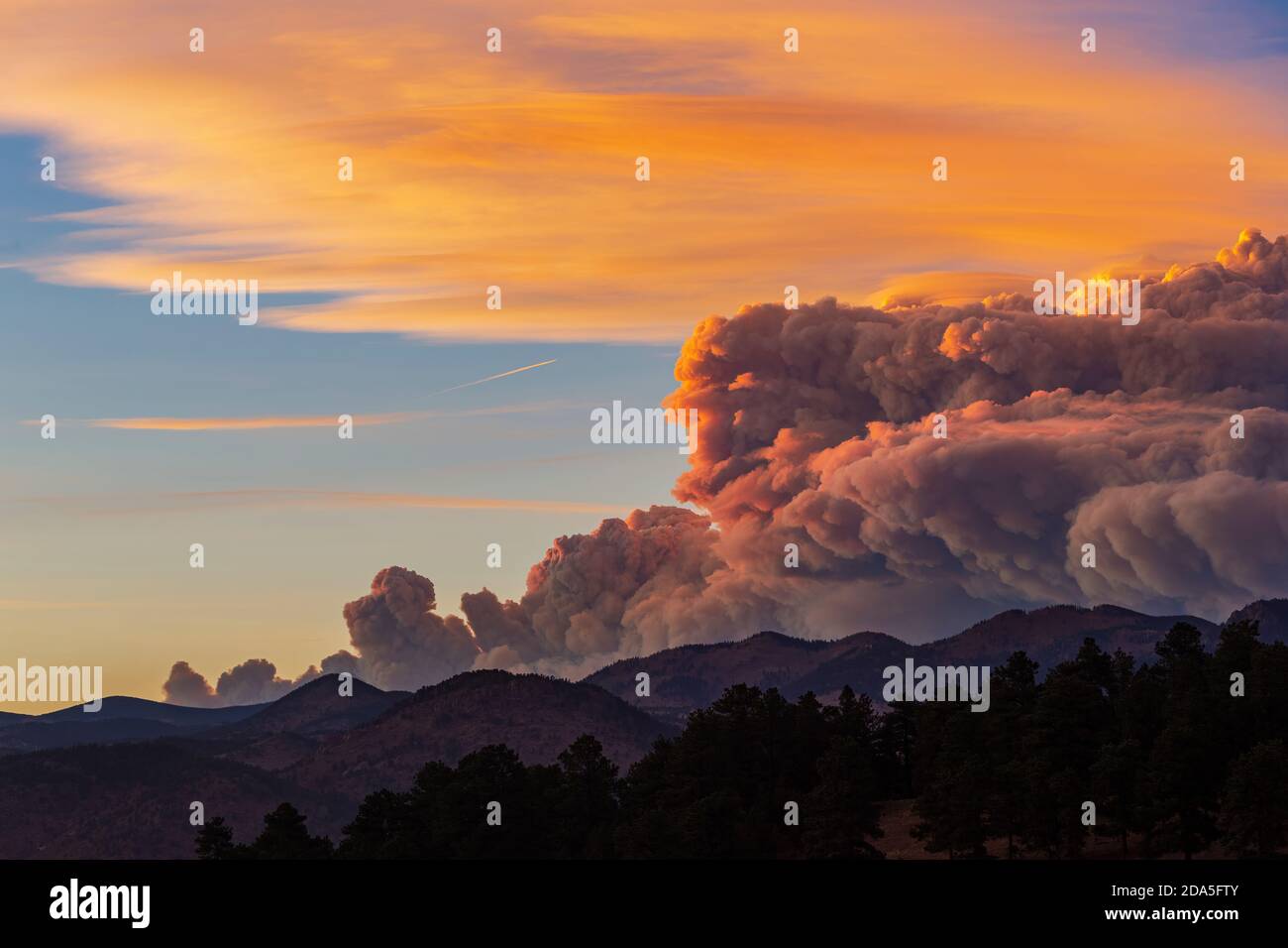 View from afar of sunsetting on smoke plume of East troublesome fire ...
